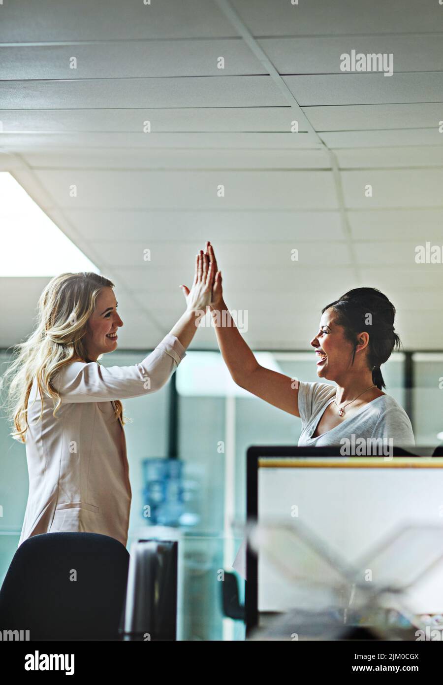Teamwork, support and happy colleagues sharing high five in a modern ...