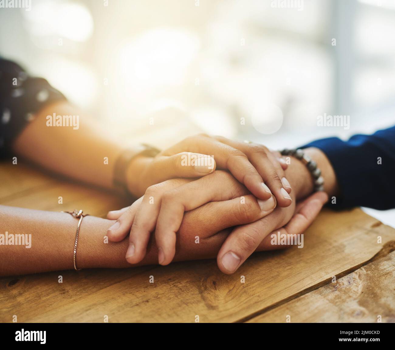 Holding hands showing care, love and support between friends, couple or ...