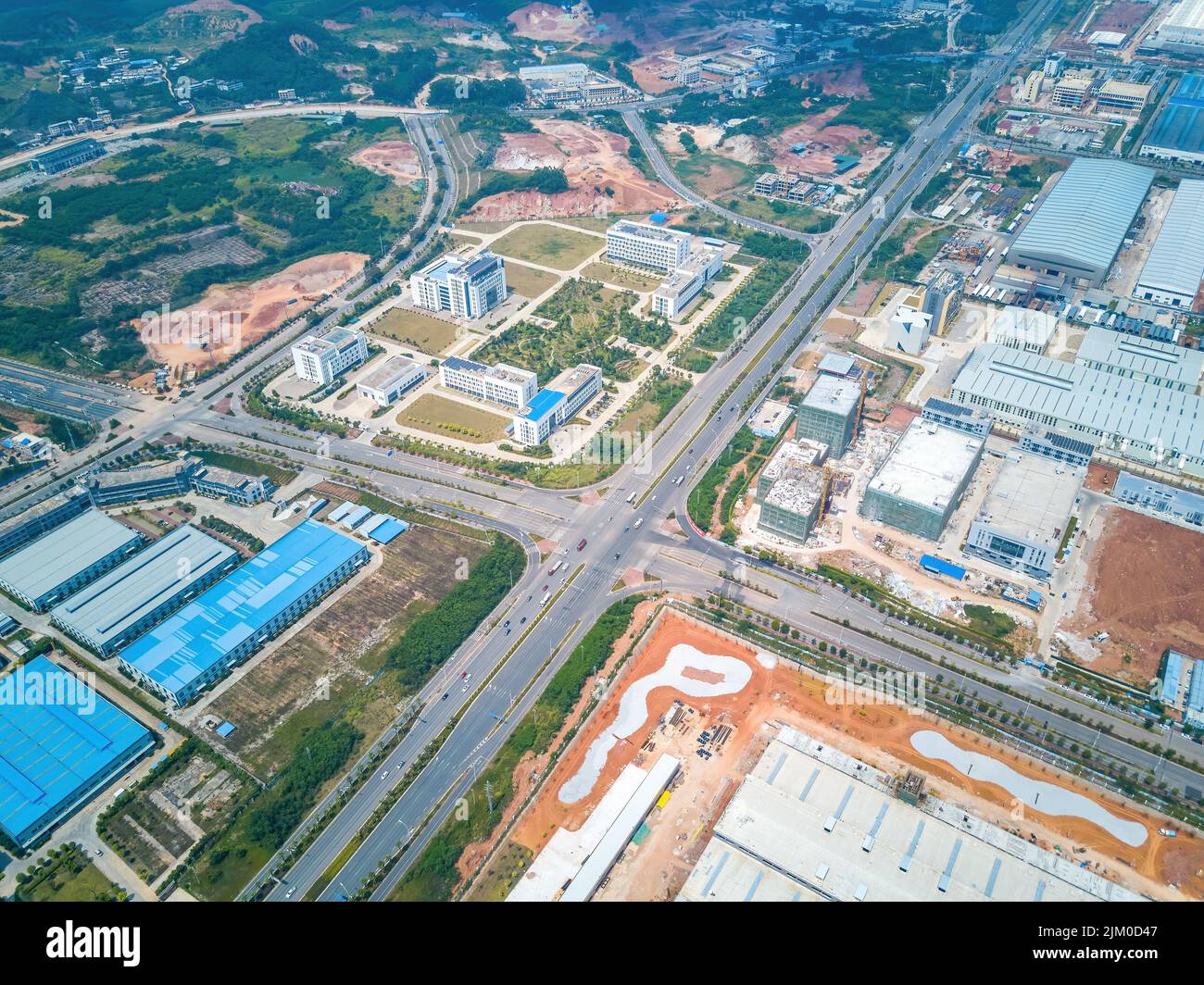 Aerial shot of road intersection in urban industrial area Stock Photo ...