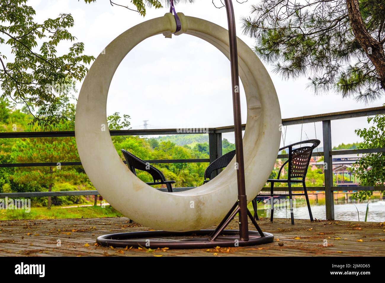 Closeup of circle shaped hanging chair in outdoor garden Stock Photo ...
