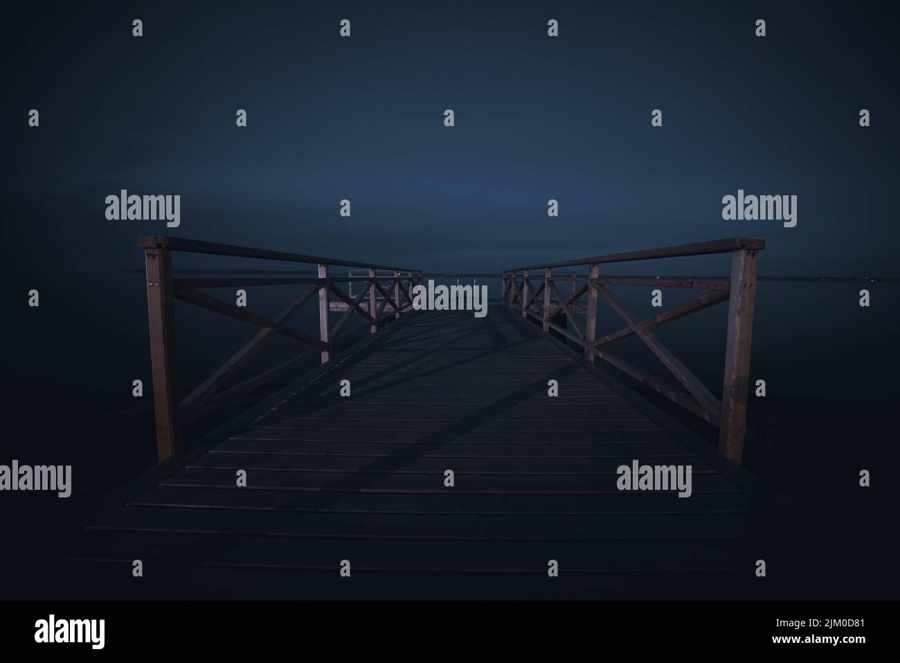 A breathtaking view of a wooden dock on dark blue sky background at ...