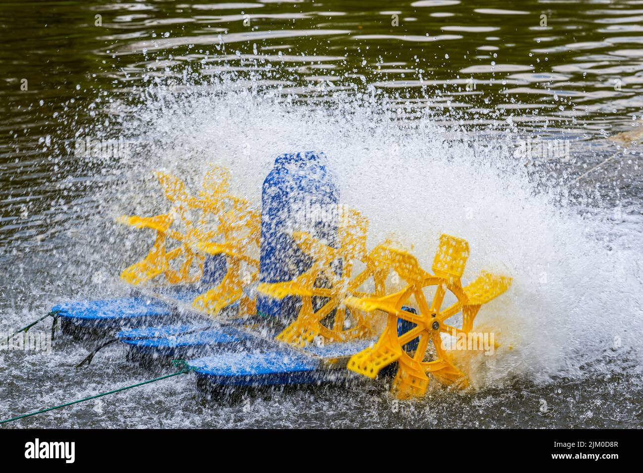 Rotary aerators used in large fish ponds Stock Photo - Alamy