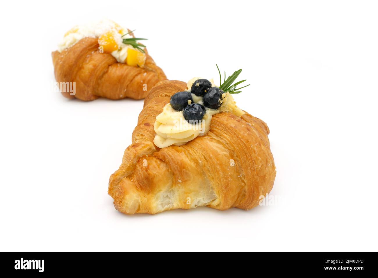 The delicious croissants with fruit topping isolated on white ...
