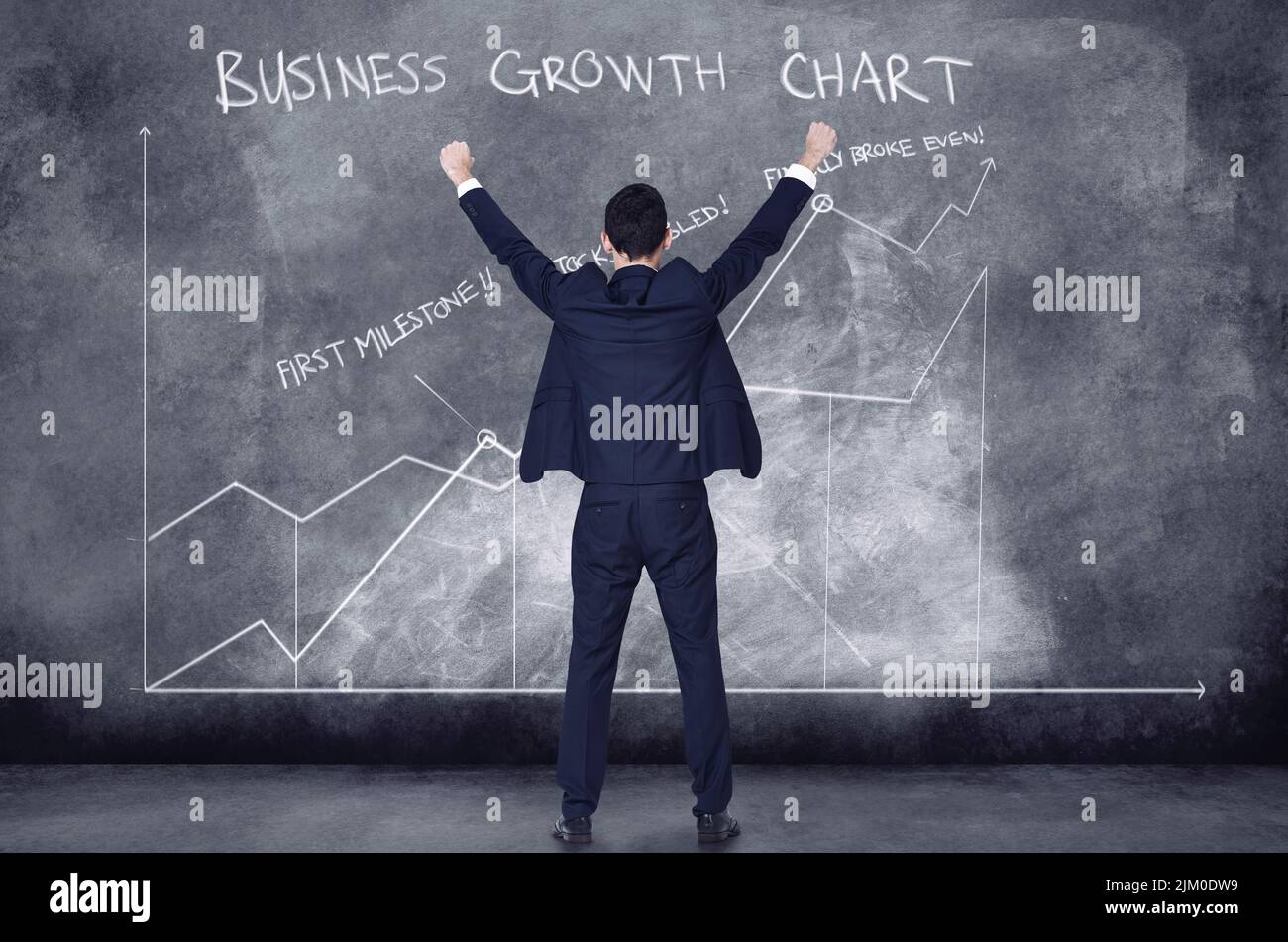 Finance business man cheering in success looking at a cgi graph, chart ...
