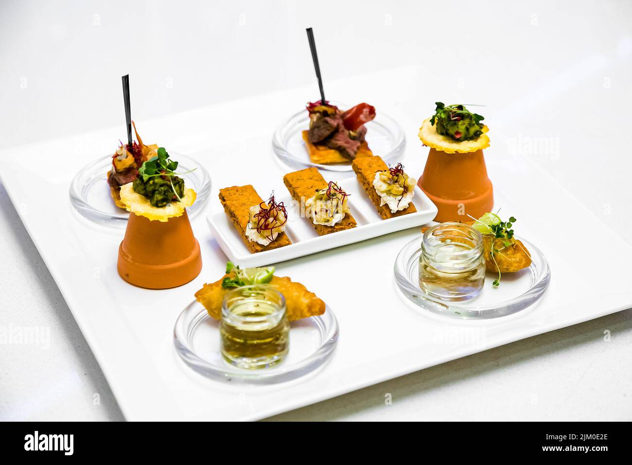 A white platter of canapes on light background Stock Photo - Alamy