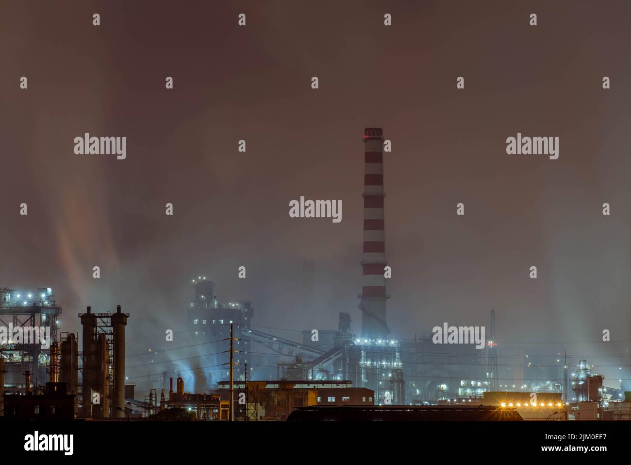 A scenic shot of a modern city illuminated at night and getting ...