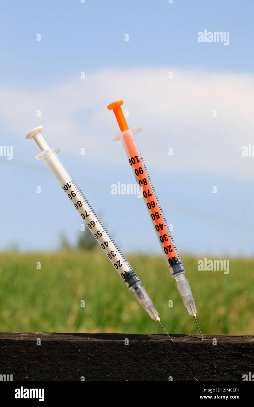 two abandoned infected syringes used by drug addicts to inject drugs ...