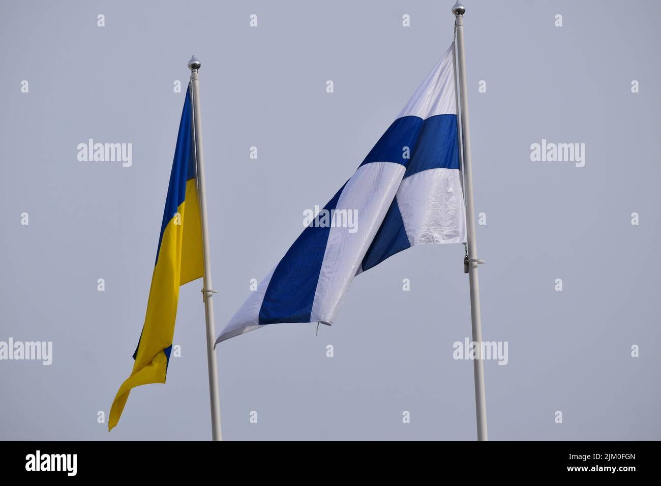 A view of the flag of Finland and Ukraine against the blue sky Stock ...