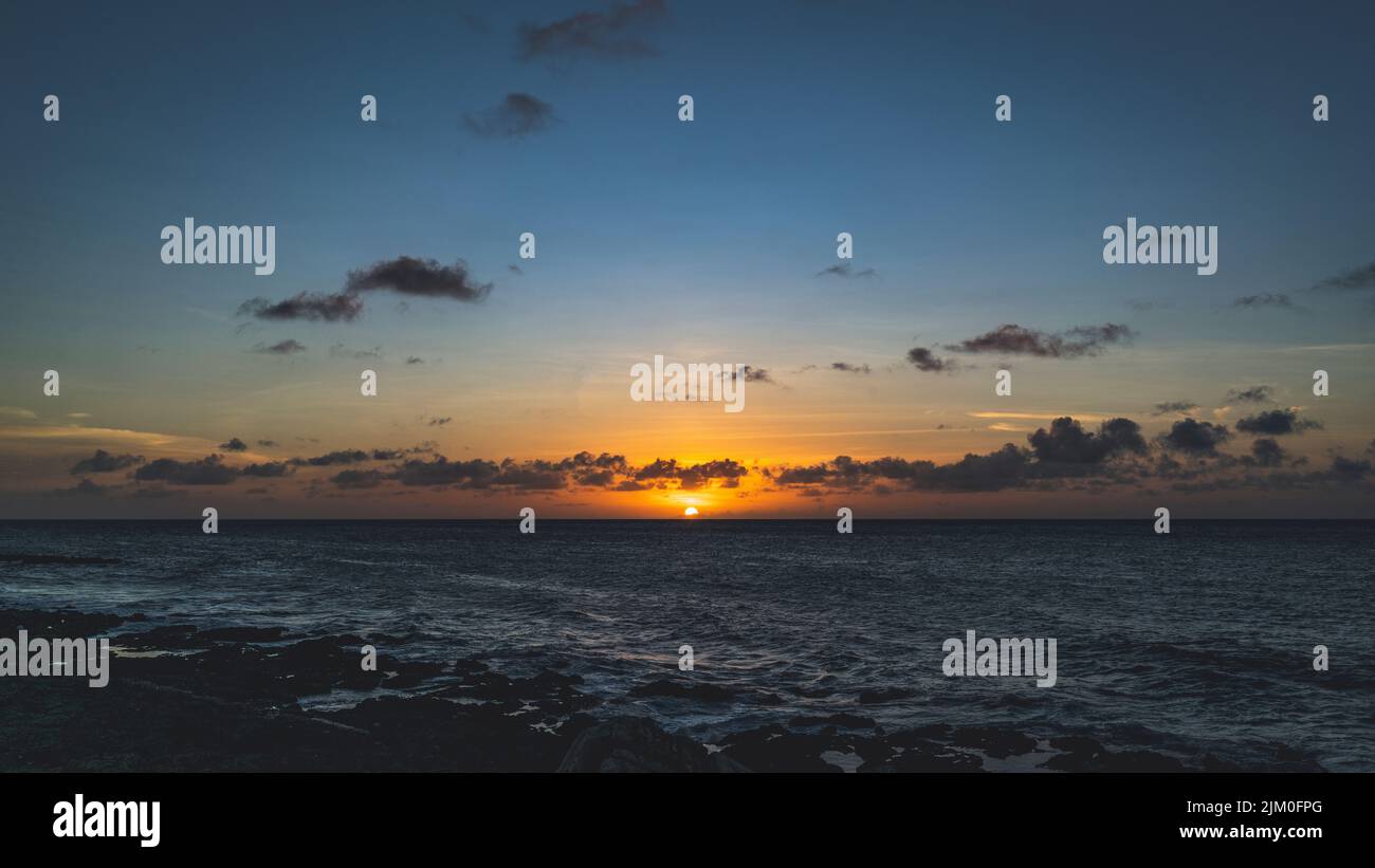 Beautiful orange sunset over waves hi-res stock photography and images ...