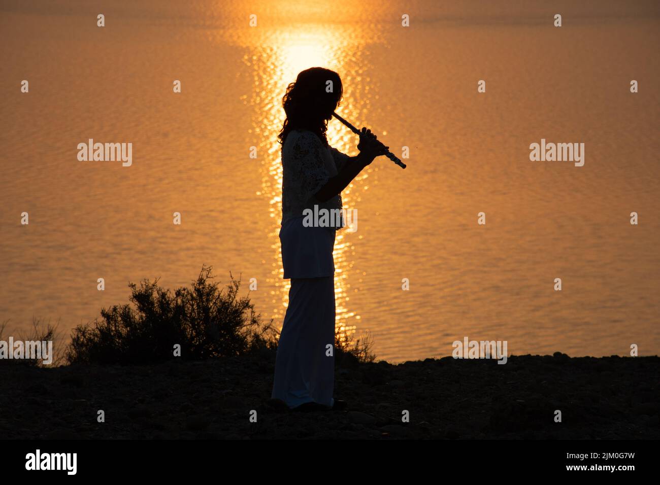 Young woman playing flute hi-res stock photography and images - Alamy