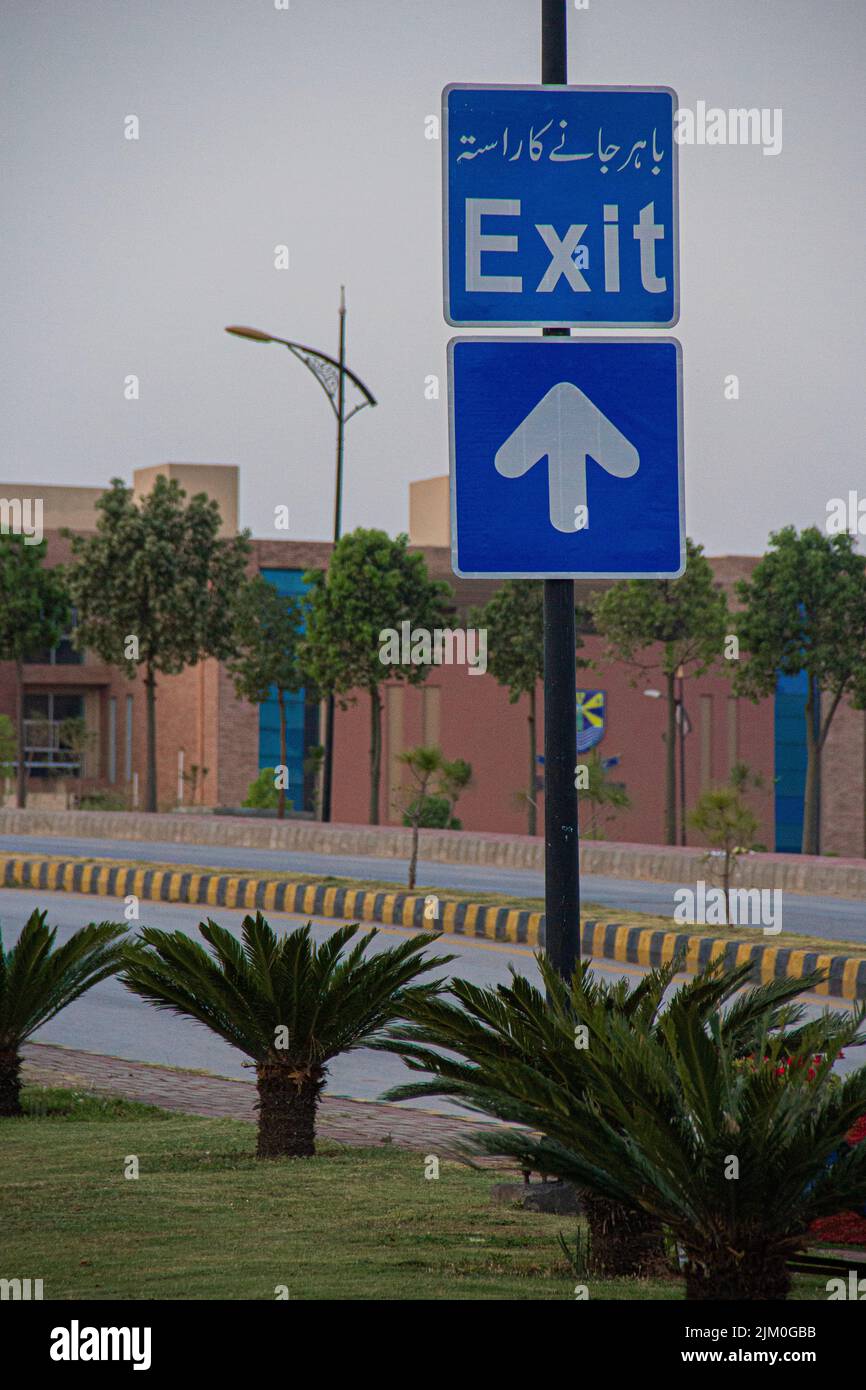 A view of traffic signs on a road with plants Stock Photo - Alamy