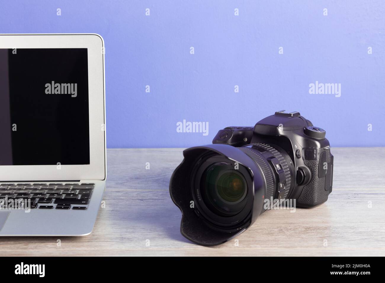 The photographer workstation with a camera on the wooden table Stock ...