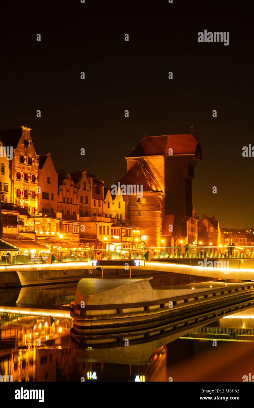 Old town in Gdansk at night. The riverside on Granary Island reflection ...