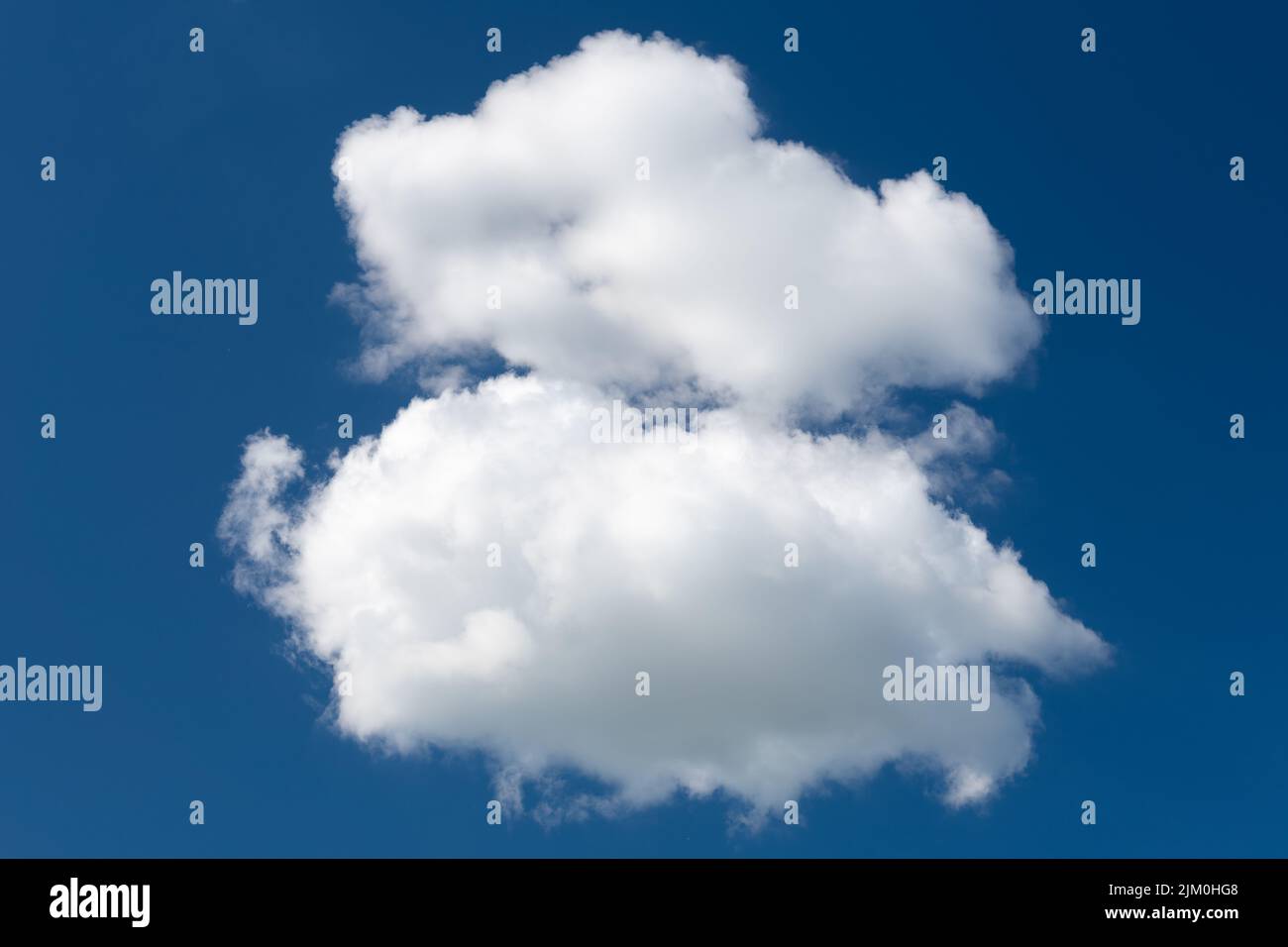 A white cumulus cloud against a dark blue daytime sky. A high resolution. Sample for copying ...