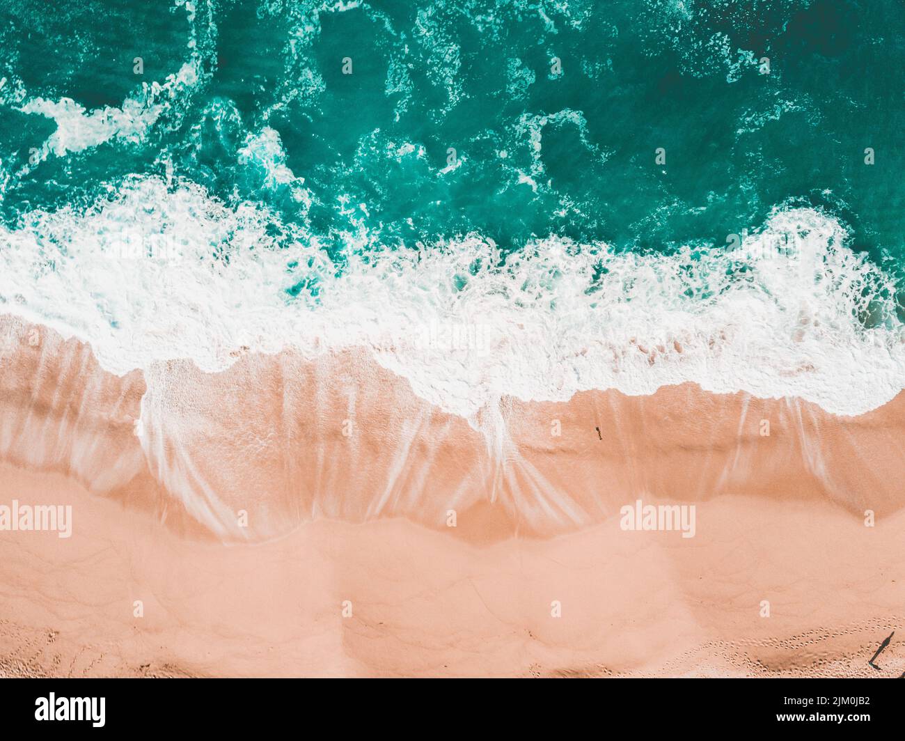 An aerial view of a sandy shore and foamy waves Stock Photo - Alamy