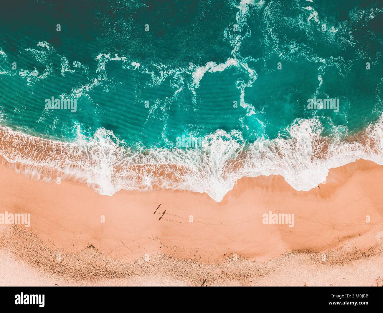 An aerial view of a sandy shore and foamy waves Stock Photo - Alamy