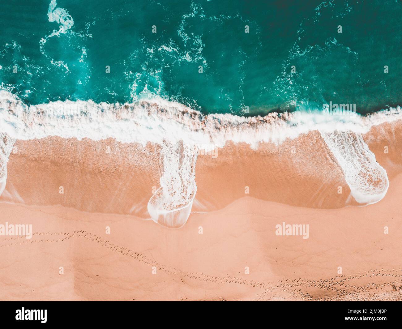 An aerial view of a sandy shore and foamy waves Stock Photo - Alamy