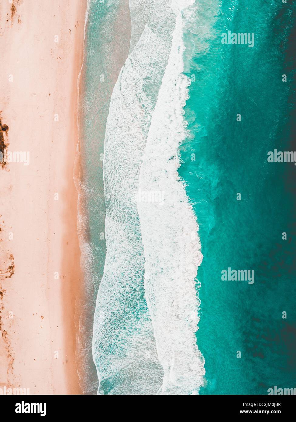 An aerial view of a sandy shore and foamy waves Stock Photo - Alamy