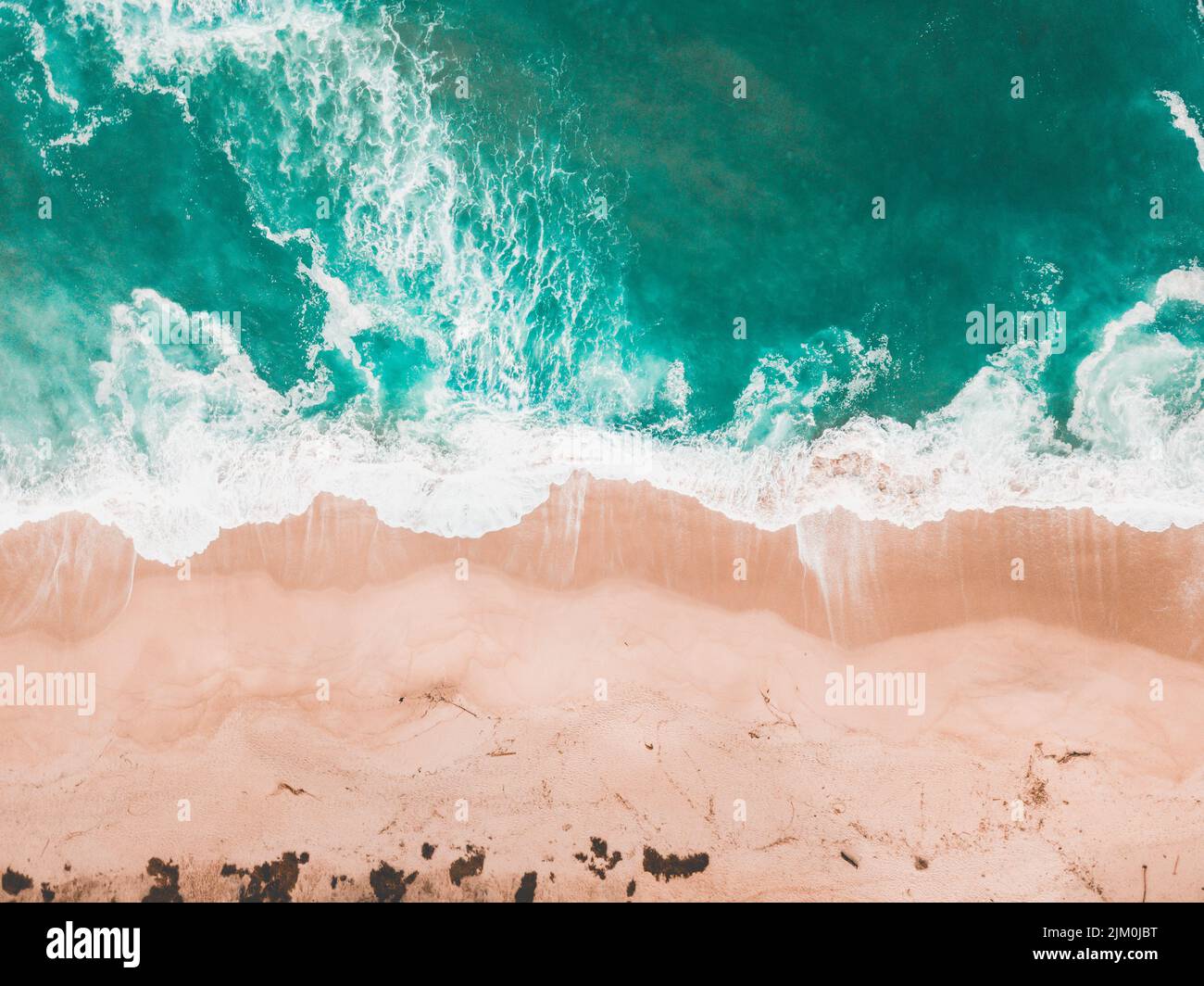 An aerial view of a sandy shore and foamy waves Stock Photo - Alamy