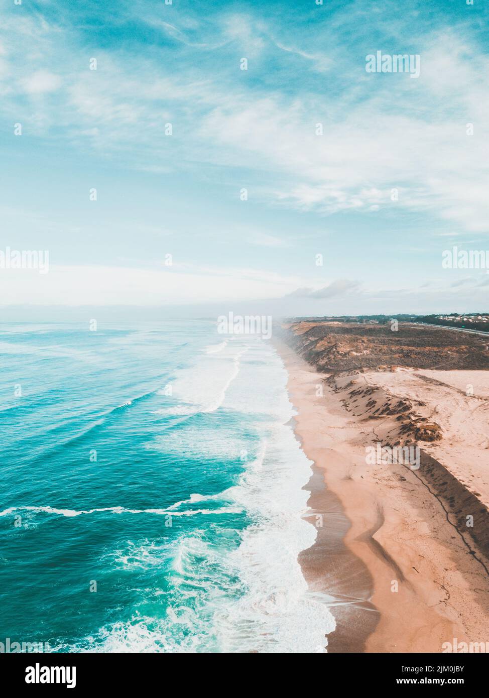 An aerial view of a sandy shore and foamy waves Stock Photo - Alamy