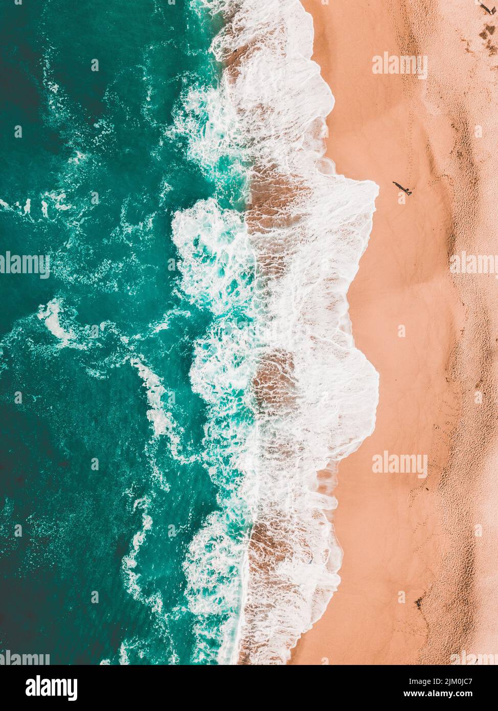 An aerial view of a sandy shore and foamy waves Stock Photo - Alamy