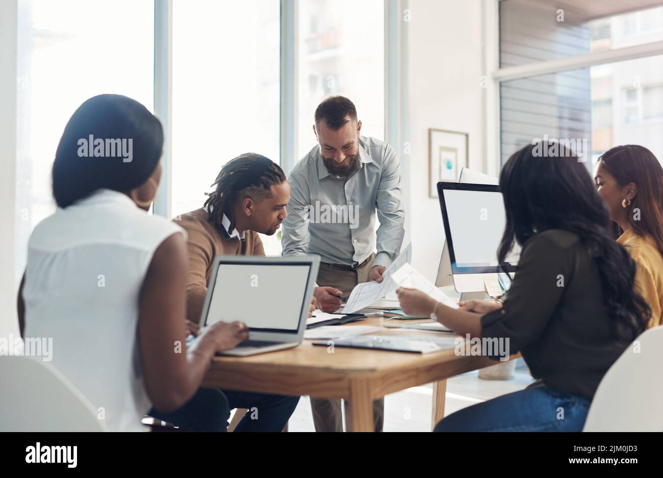 Take a look at this document. a diverse group of businesspeople using ...