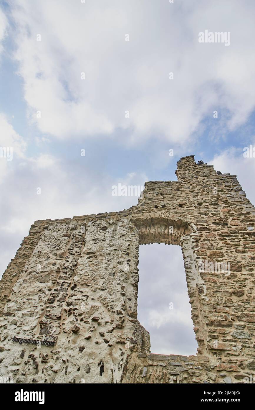 A low angle shot of arch Ruins of the Lowenburg castle in Monreal Eifel ...