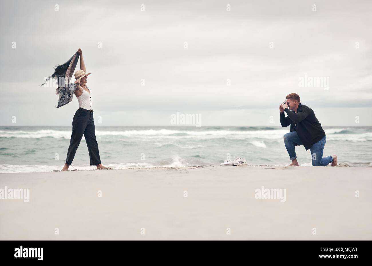 Strike A Pose Babe A Man Taking Pictures Of His Girlfriend While Spending Time At The Beach