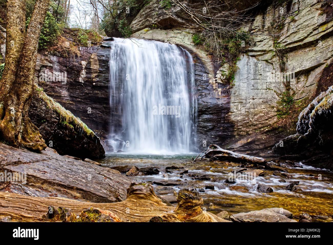 A beautiful view of Looking Glass waterfall flowing between cliffs ...