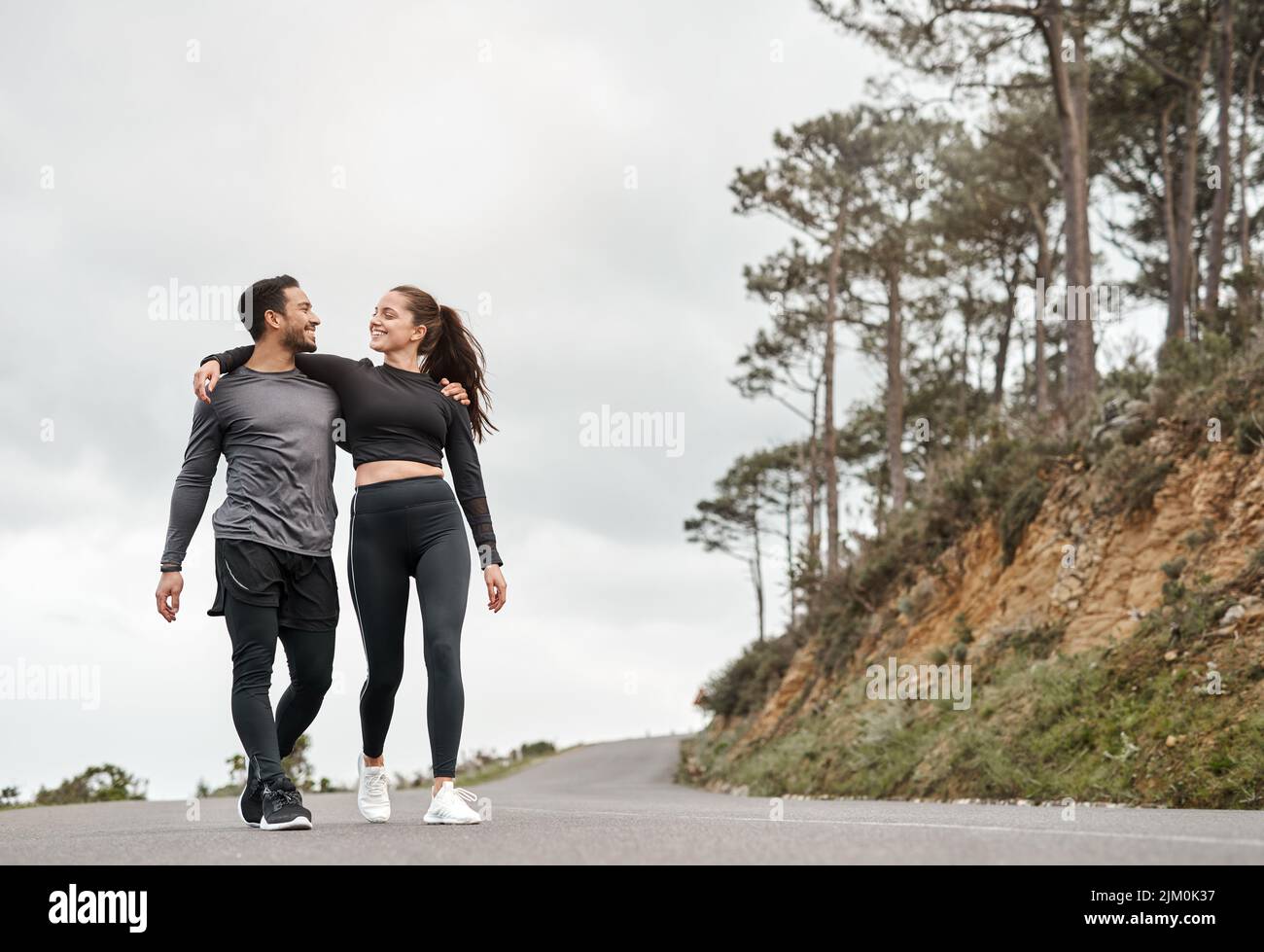 We did good today. Full length shot of two young athletes walking with ...