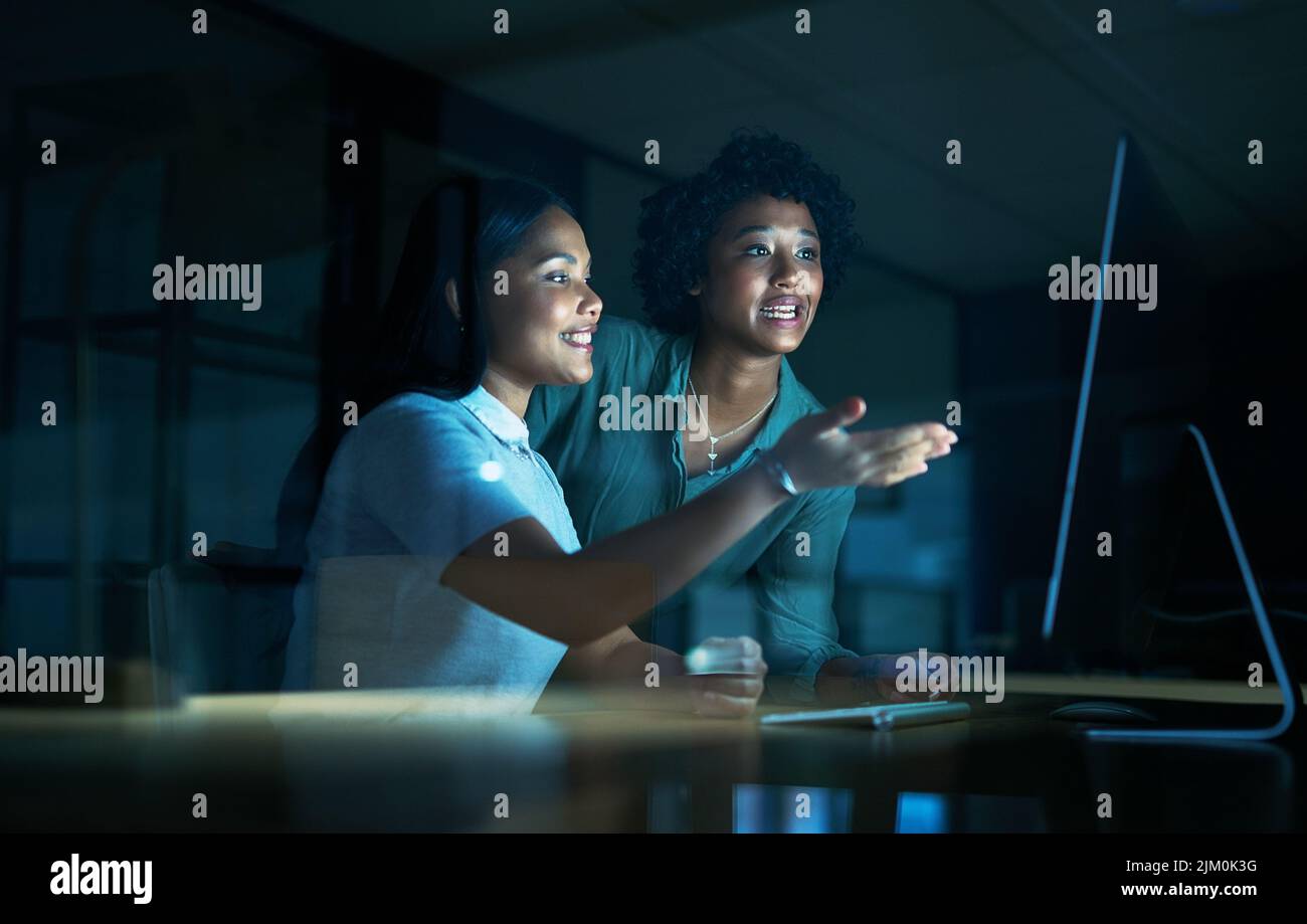 Good communication gets good results. two young businesswomen using a ...