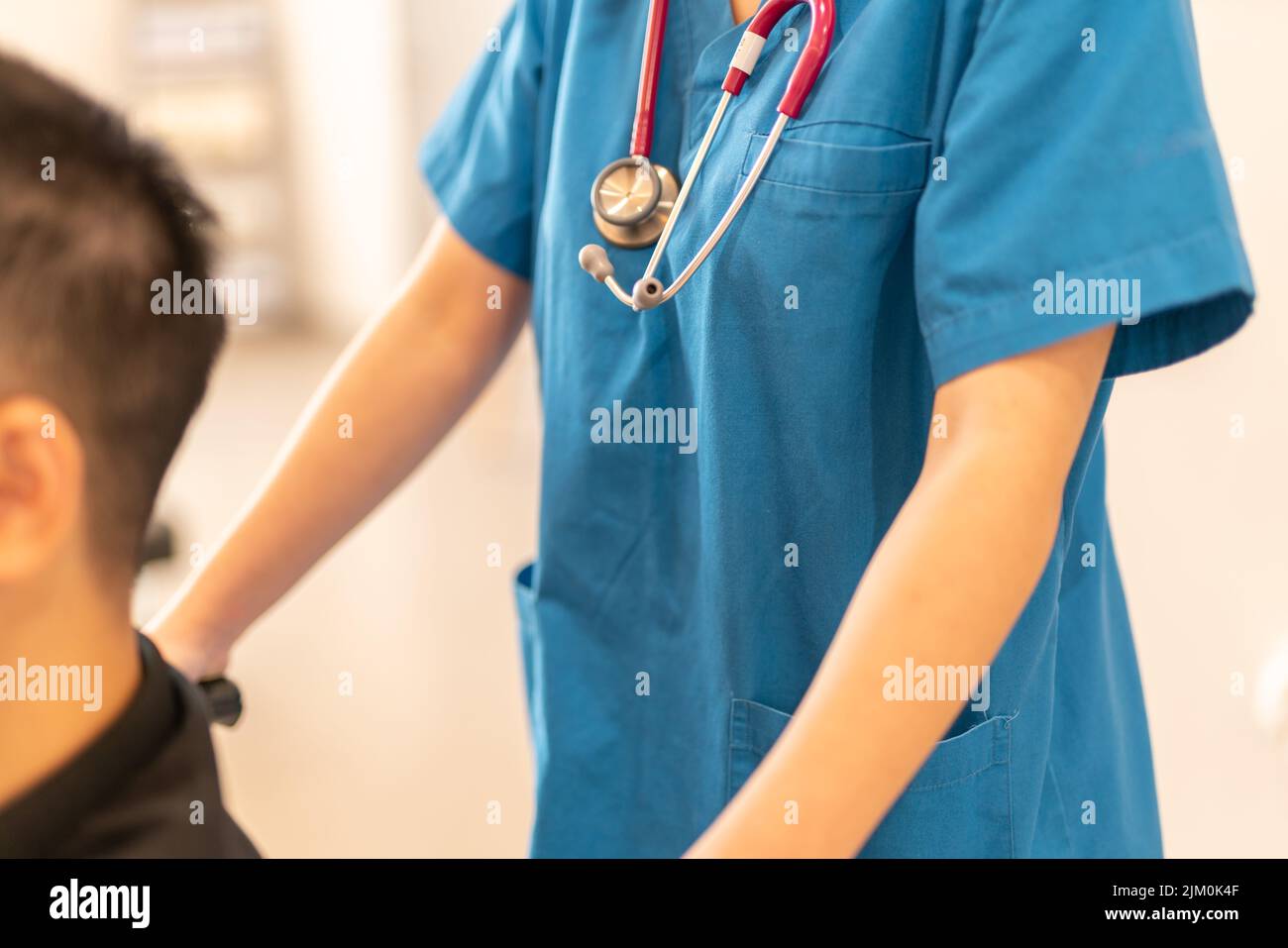 unrecognizable doctor help disable patient with wheelchair Stock Photo ...