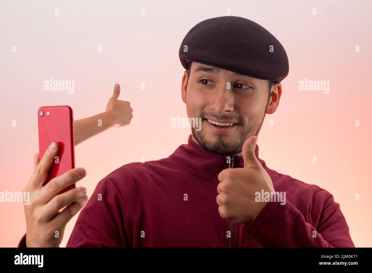 Thumbs up young man using hi-res stock photography and images - Alamy