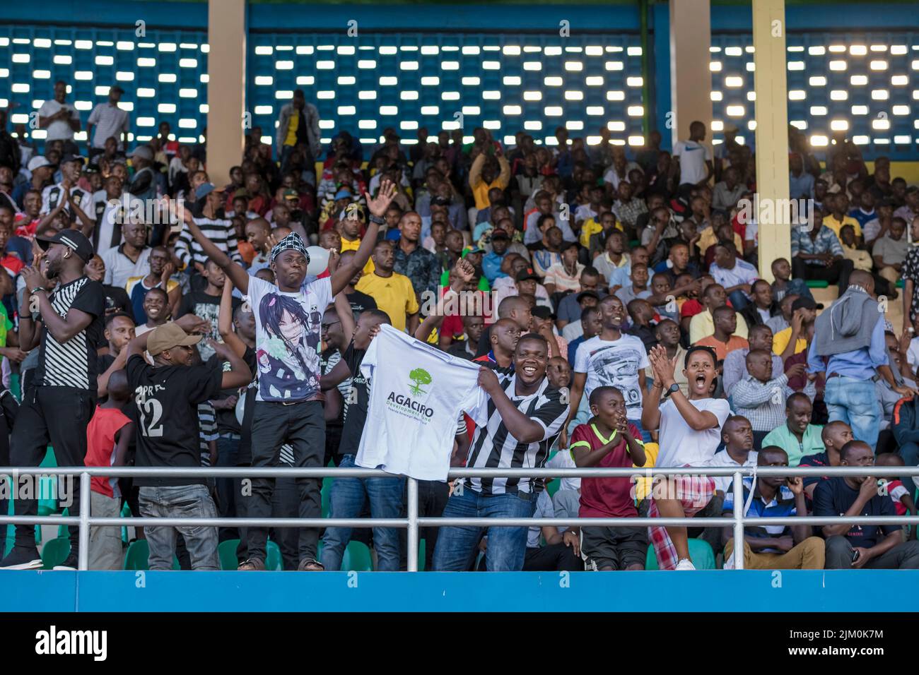A crowd of people cheering at a football game stadium in Rwanda Stock ...
