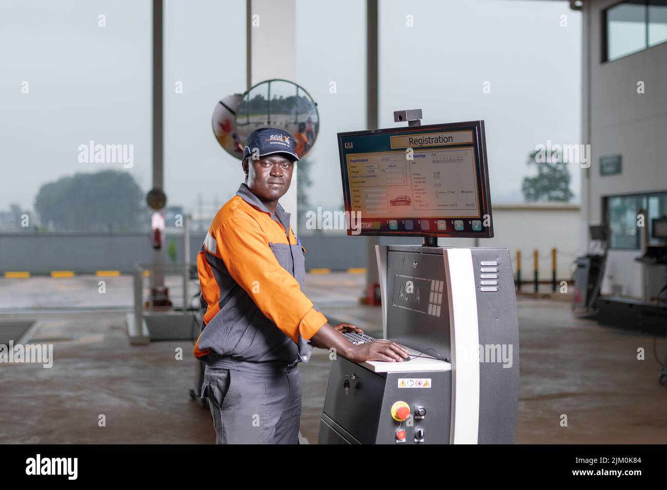 A Black male engineer operating an auto-express checkpoint machine ...