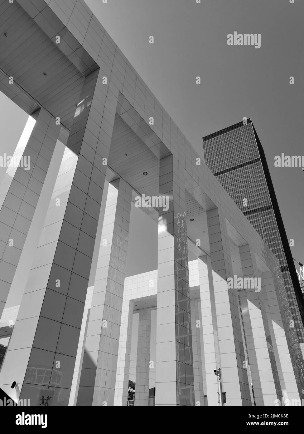 A vertical greyscale low angle shot of modern buildings Stock Photo - Alamy