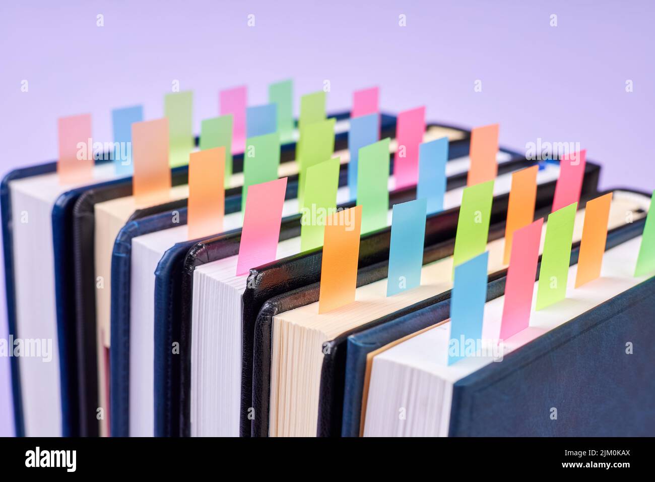 Close-up of a stack of office notepads with colorful sticky page ...