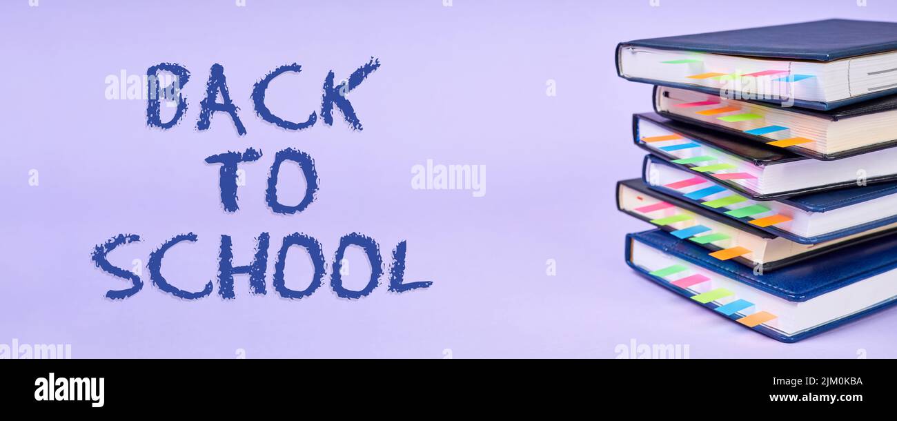 A stack of notepads with colorful sticky page markers as a back to ...