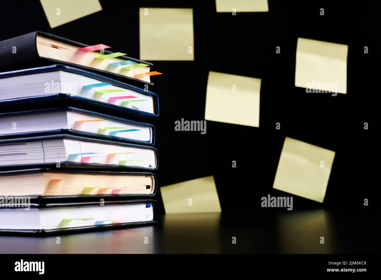 Close-up of a stack of office notepads with colorful sticky page ...