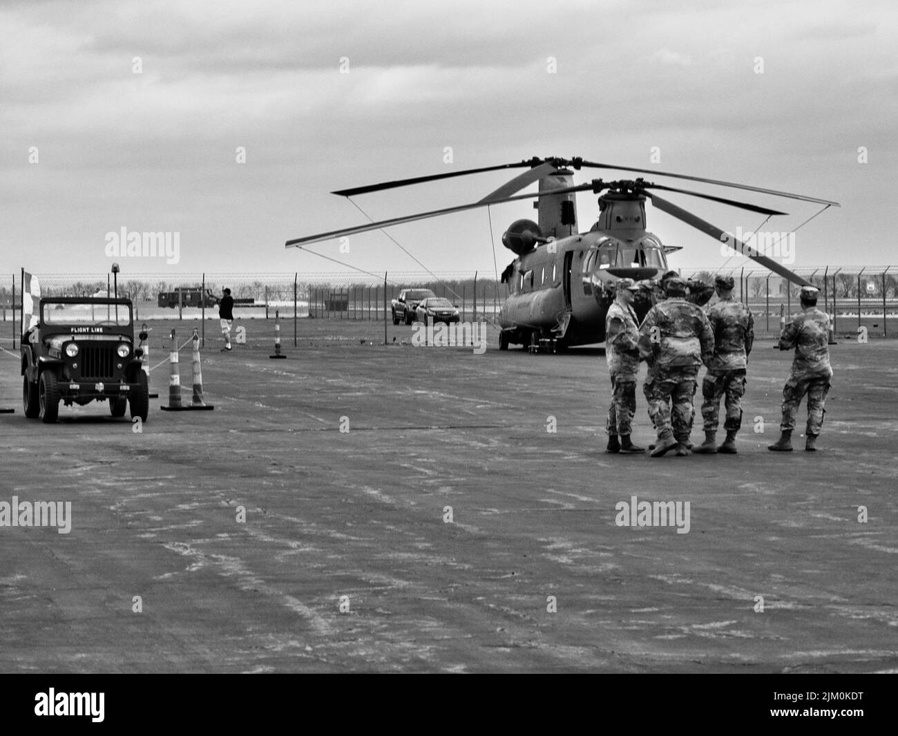 A grayscale shot of helicopters and military vehicles in the USA Stock ...