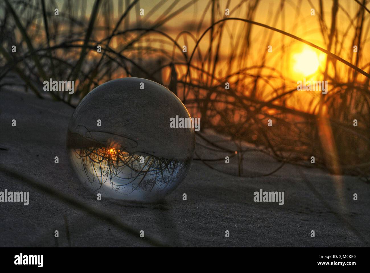 Glass ball in rays sunset hi-res stock photography and images - Alamy