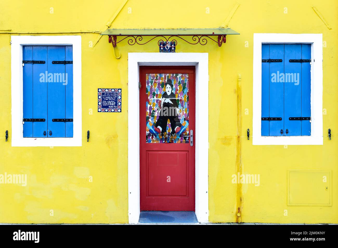 The facade of a beautiful colorful and small house with two blue ...
