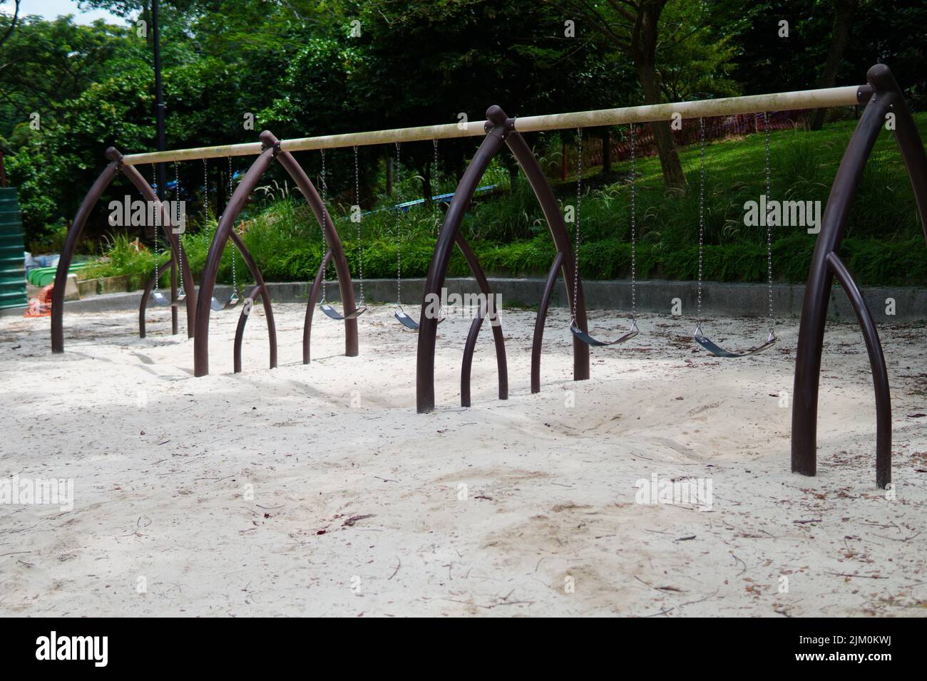 A rusty playground swings in a park Stock Photo - Alamy