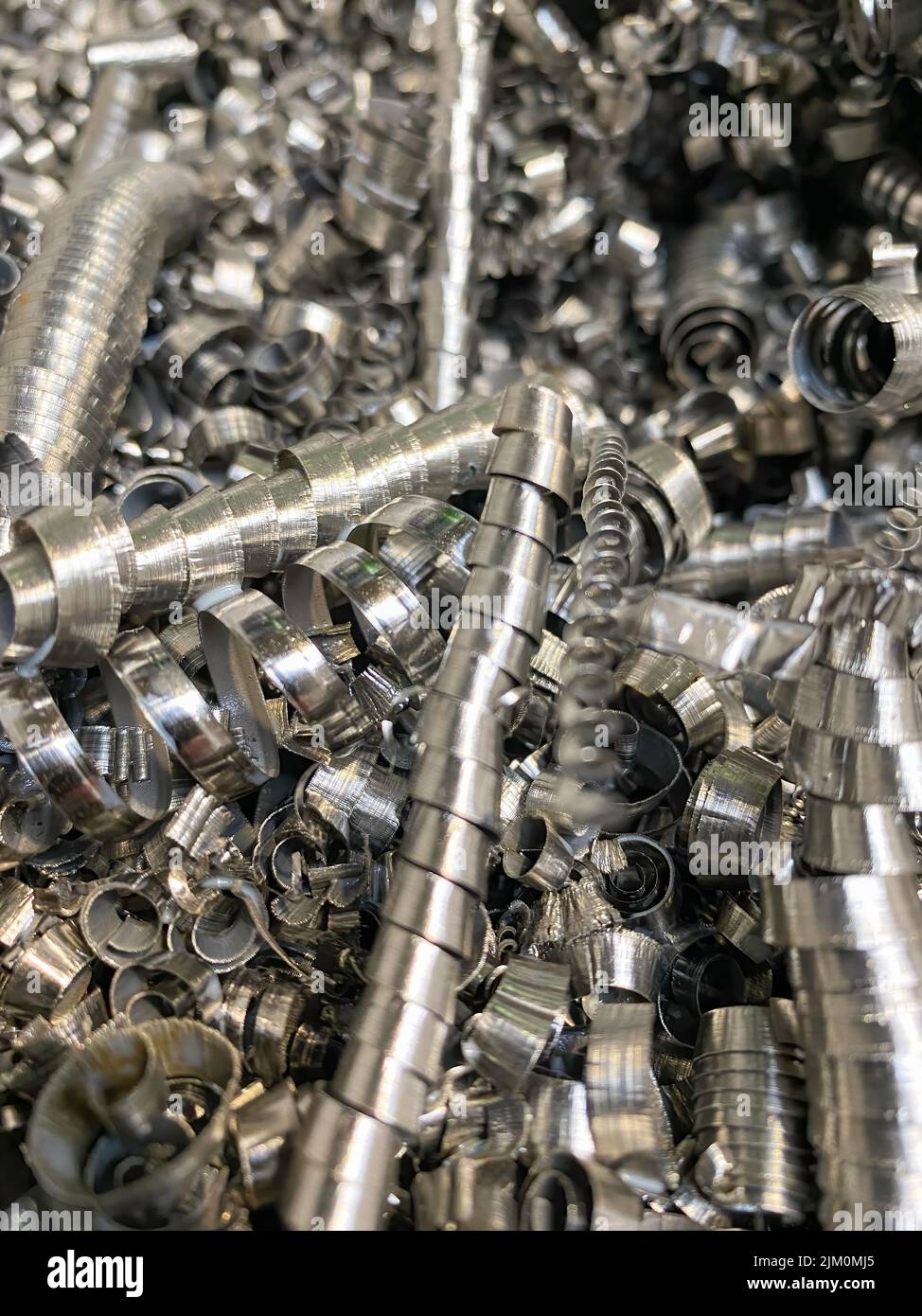 Stainless steel curly turnings waste from a lathe for recycling. High ...