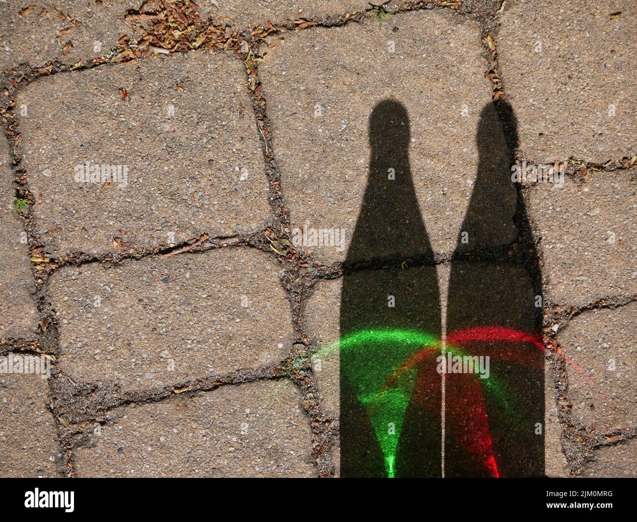 Green and red shadow of two bottles on pavement Stock Photo - Alamy