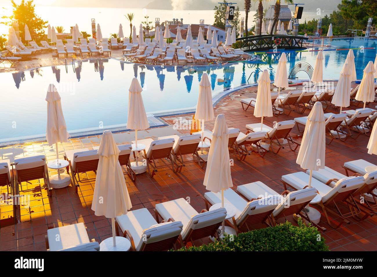 Pool with lounge chairs in resort hotel with mountain view Stock Photo ...
