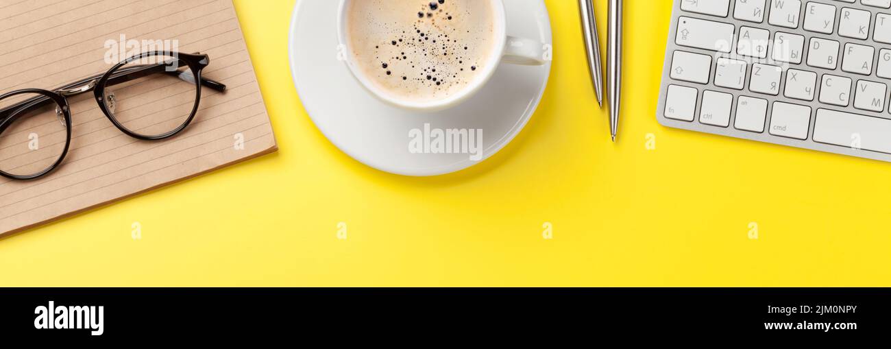 Office yellow workplace backdrop with coffee cup, supplies and computer ...