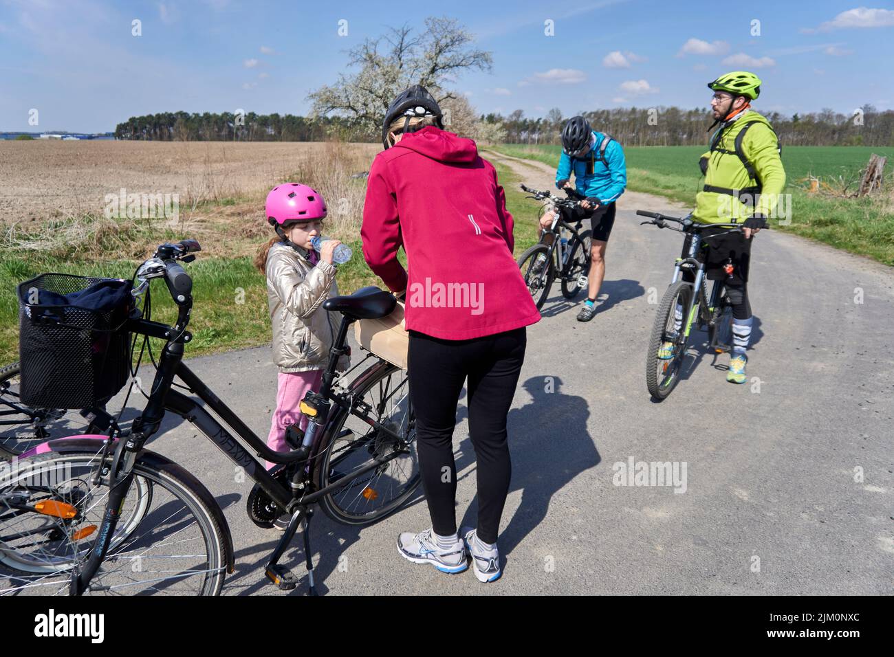A group of active people with bicycles having a break during a bike ...
