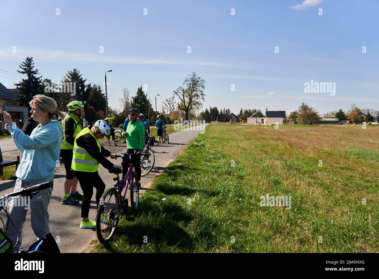 A group of active people with bicycles having a break during a bike ...