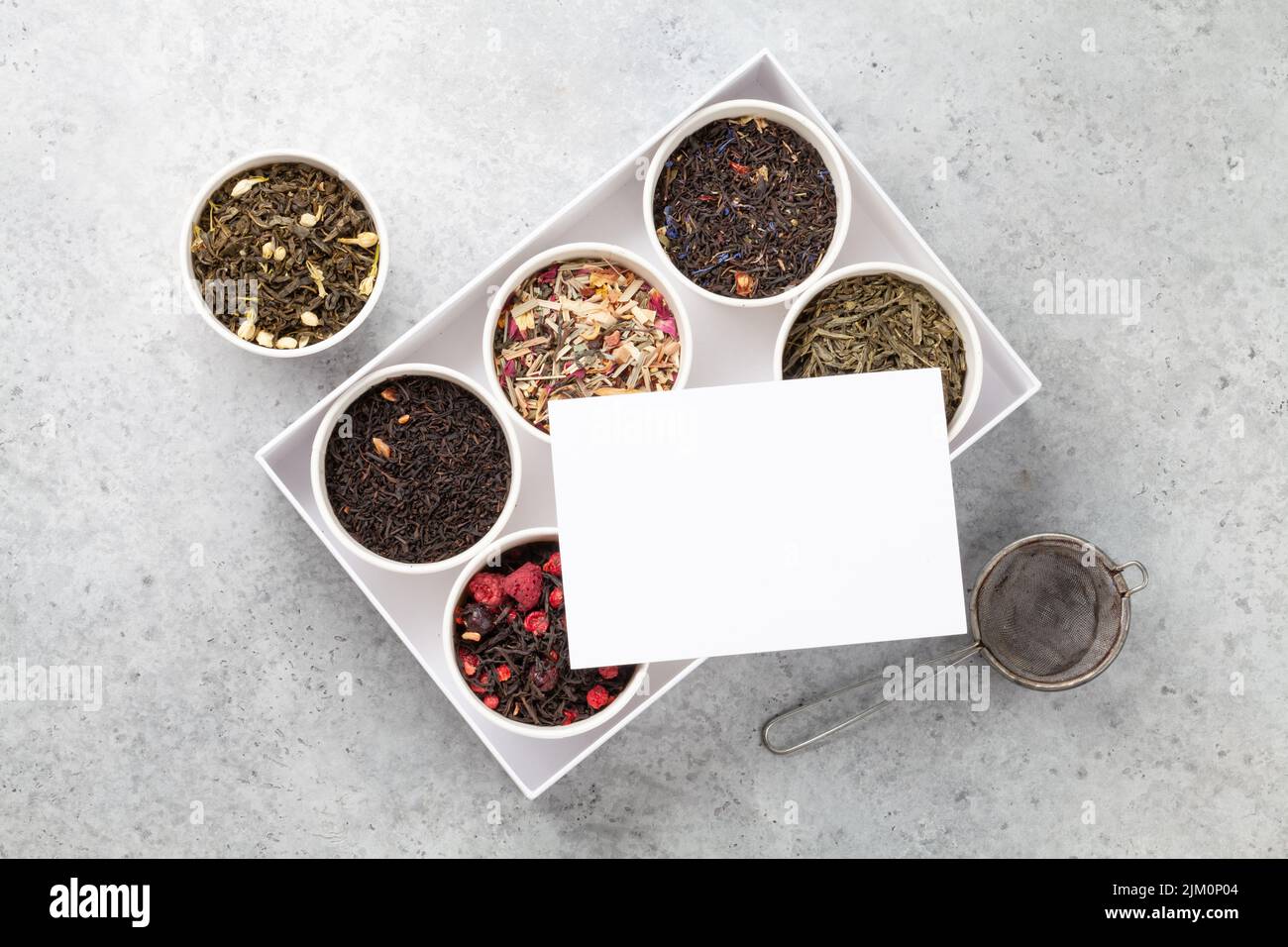Various dried tea in box. Herbal, green and black tea leaves. Top view ...